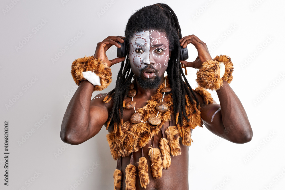 native african man in ethnic cape using heaphones for the first time ...