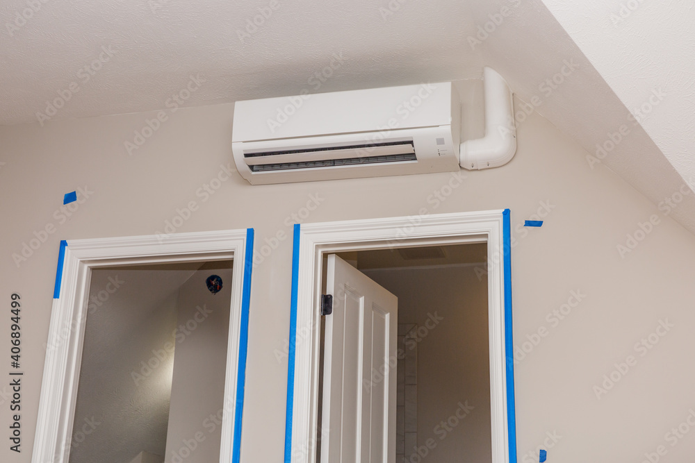 Room with painter's tape around doors and mini-split air conditioning ...