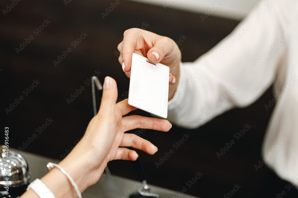 Woman receiving door key in hotel front desk Stock Photo | Adobe Stock