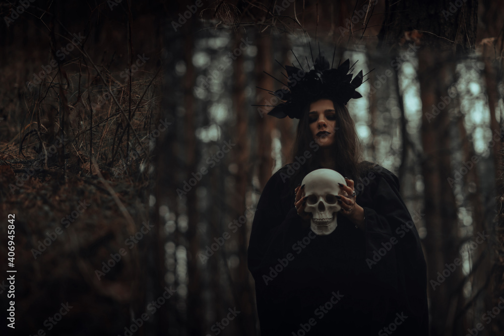 reflection of an evil scary witch with a dead man's skull in a mirror ...