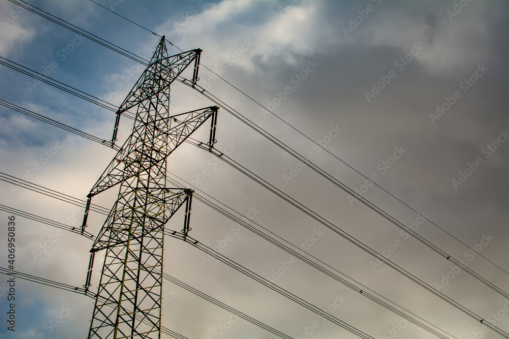 Electrical power mast in front of dark clouds as a concept of a ...
