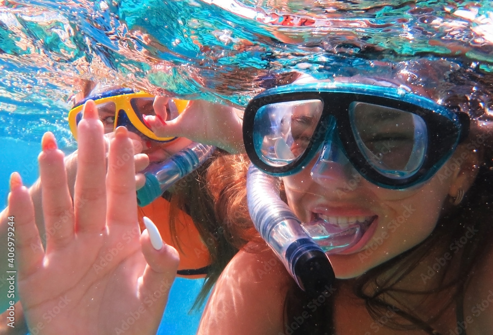 Underwater shot. Cute teenage girl diving with scuba in a tropical sea ...