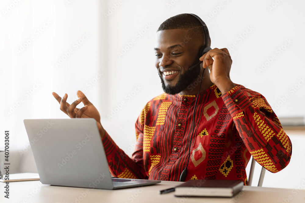 Black Man In African Shirt Making Video Call With Laptop And Headset ...