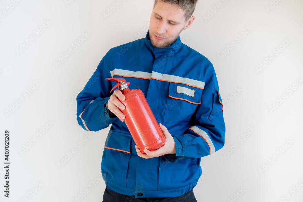 fireman man holding a fire extinguisher, safe work and precautions ...