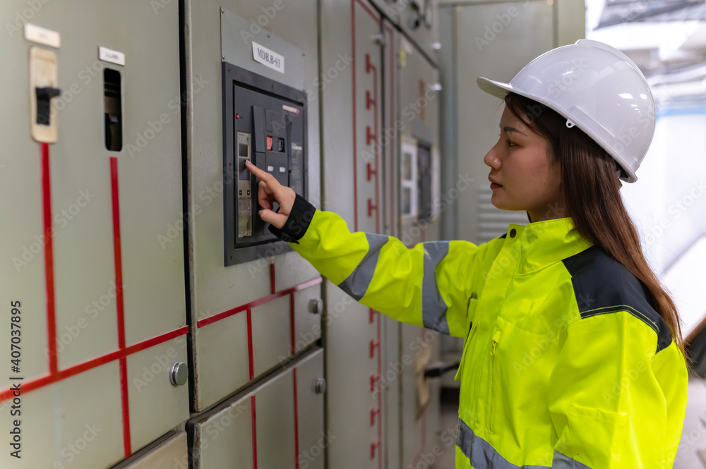 Asian electric engineer holding clipboard for checking and monitoring ...