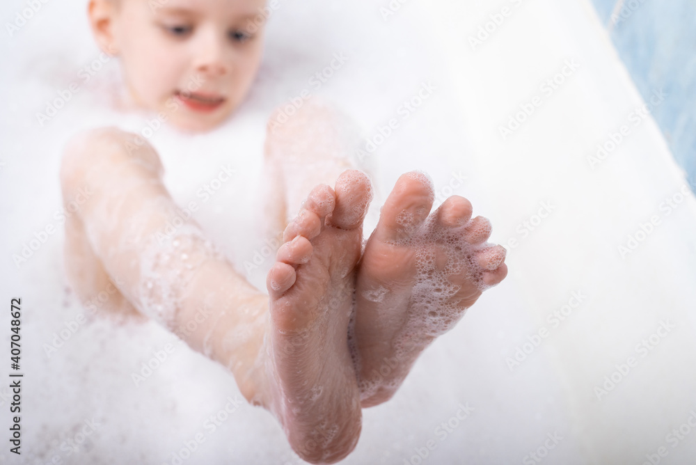 Child's foot in soapy foam. Taking a bath, hygiene procedures. Stock ...