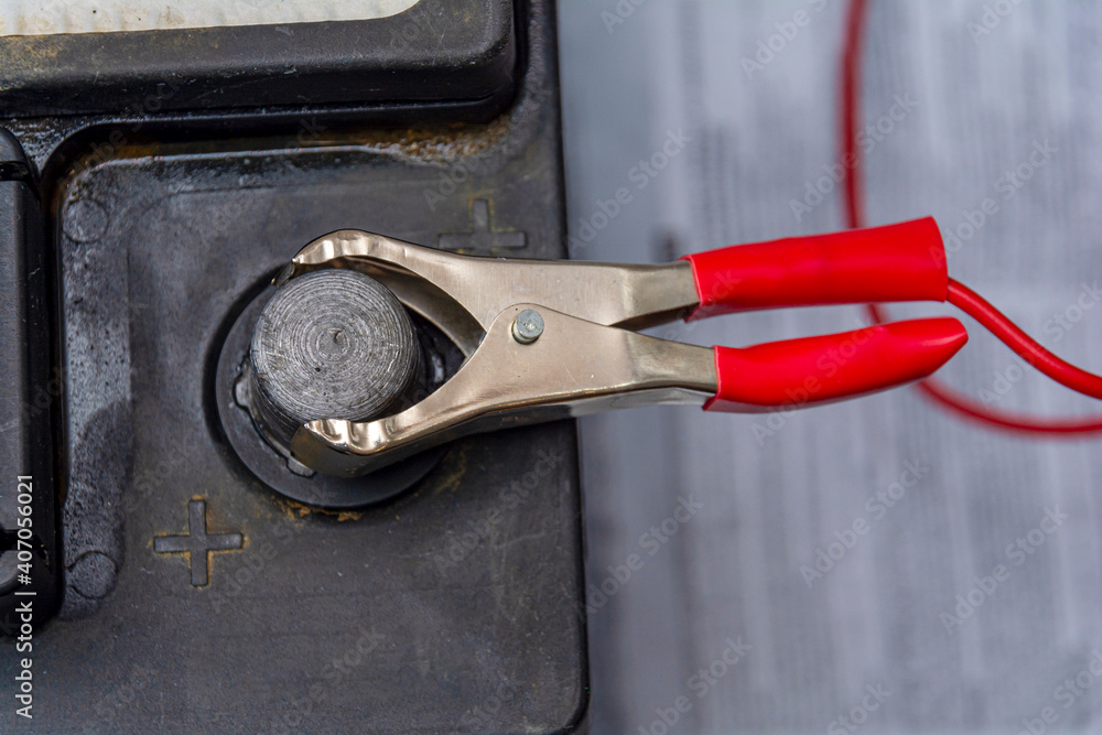 positive terminal of the charger on the battery terminal. charging and ...