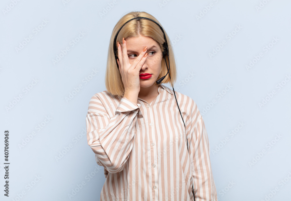 blonde woman feeling bored, frustrated and sleepy after a tiresome ...