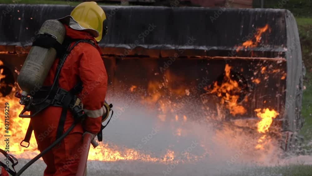 FHD Slow motion: Firefighter using Chemical foam fire extinguisher to ...