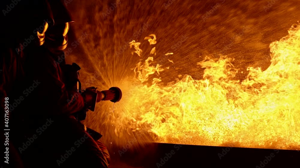 4K UHD Firefighters using Twirl water fog type fire extinguisher to ...