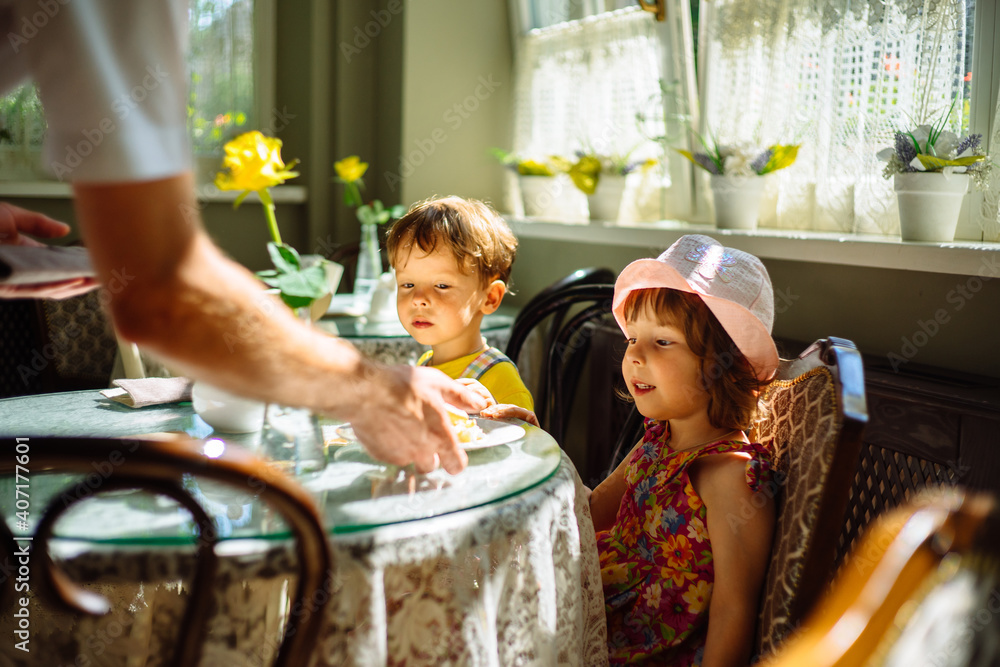 Happy children, twins, boy and girl wait order in cafeteria. Family ...