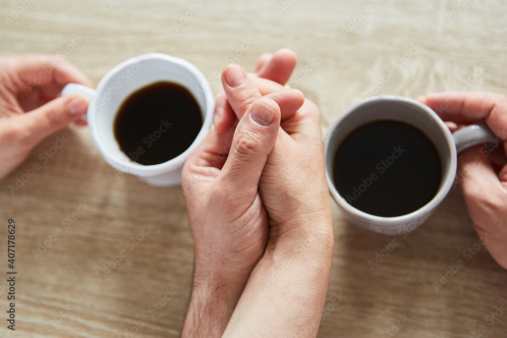 Two hands are touching while drinking coffee Stock Photo | Adobe Stock
