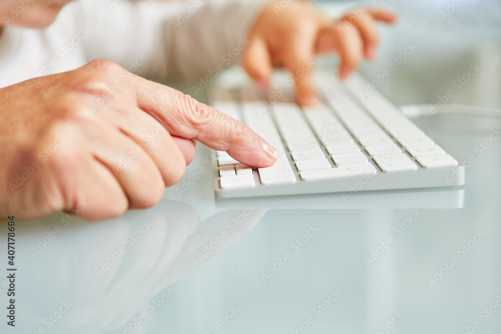 Hand of elderly woman and child on computer keyboard Stock Photo ...
