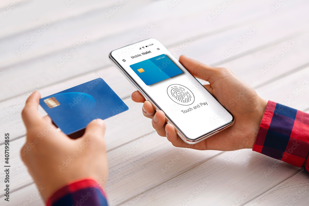 Guy Using Phone And Credit Card Paying With E-Wallet Indoors Stock ...