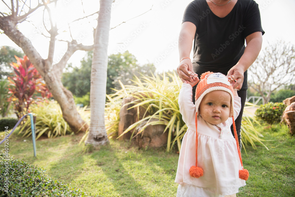 My little girl takes first steps. family happy little baby learning to ...