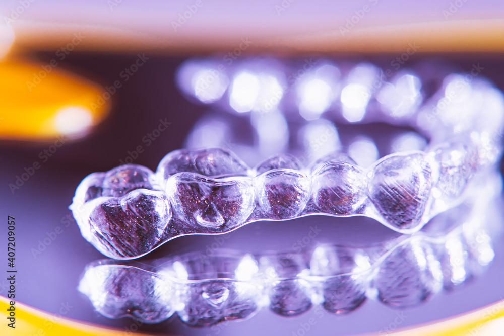 Invisible dental teeth brackets tooth aligners on purple background ...