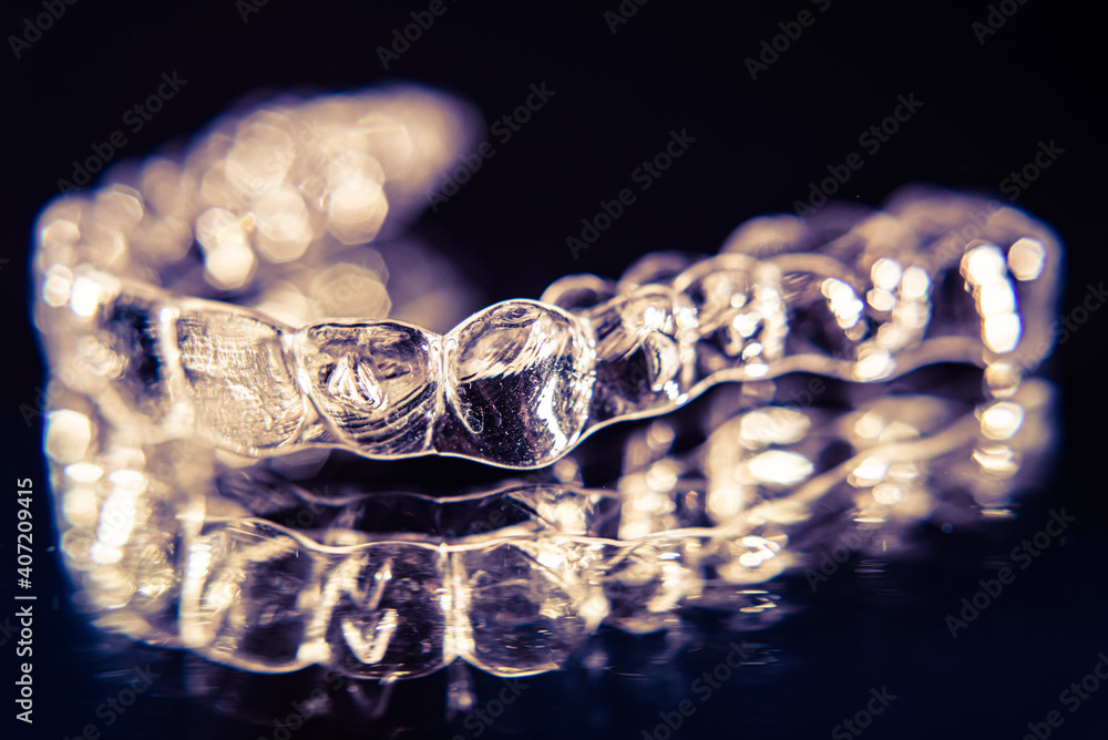 Invisible dental teeth brackets tooth aligners on black background ...