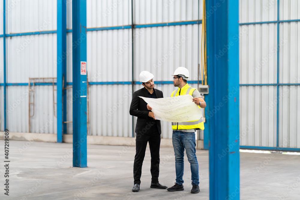 Building designers and foreman are looking at floor plans, layouts ...