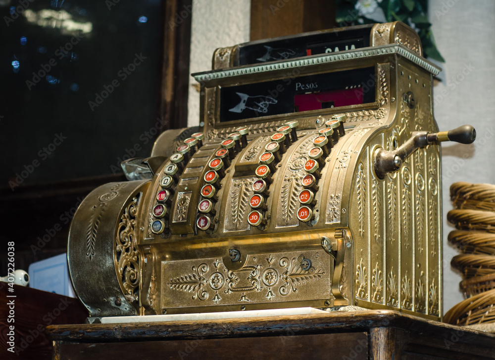 Vintage gold cash register in shop window. Antiques. Commercial ...