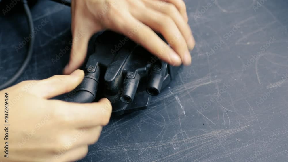 Connecting the ignition distributor wire of the car engine and the high ...