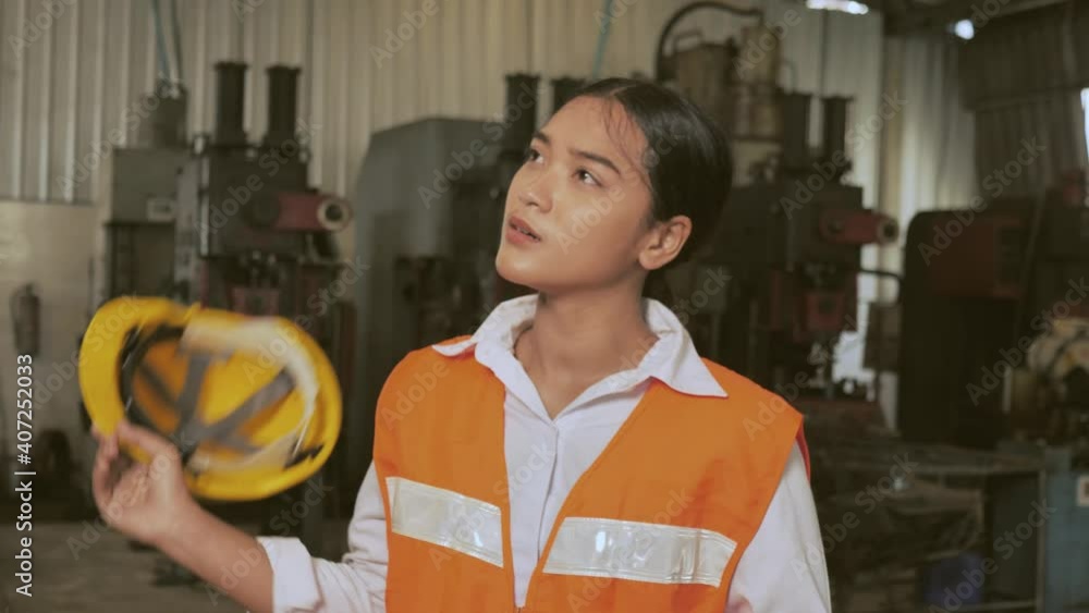 Tired woman worker Asian labor hard work in hot factory wiping away ...