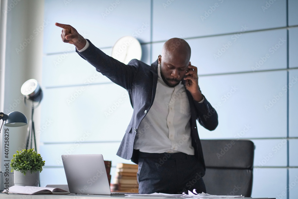 frustrated African American businessman talking on phone annoyed ...