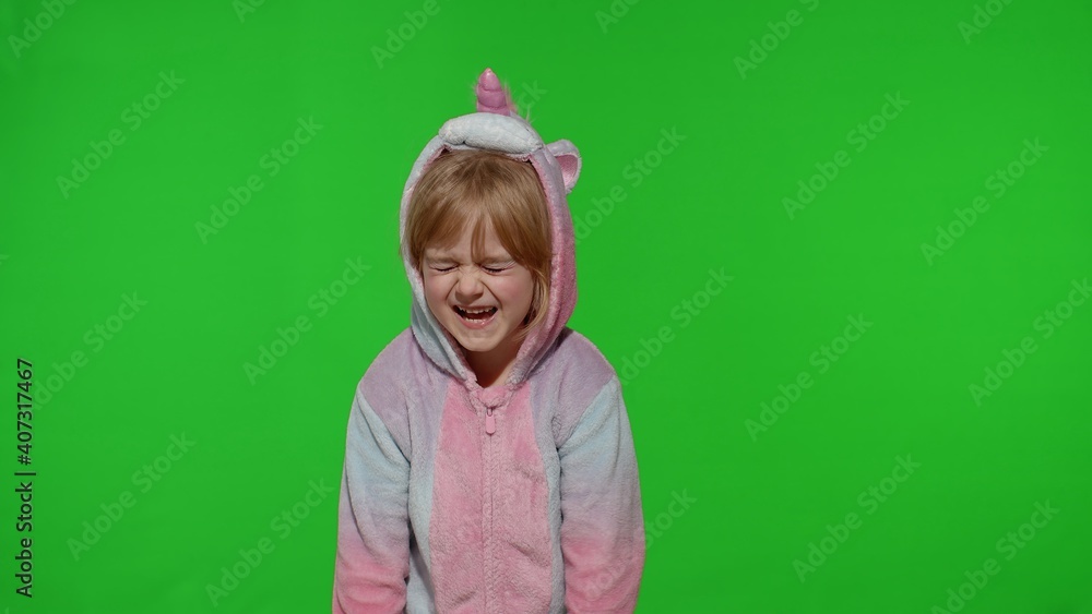 Young little blonde child 5-6 years old in unicorn costume crying with ...
