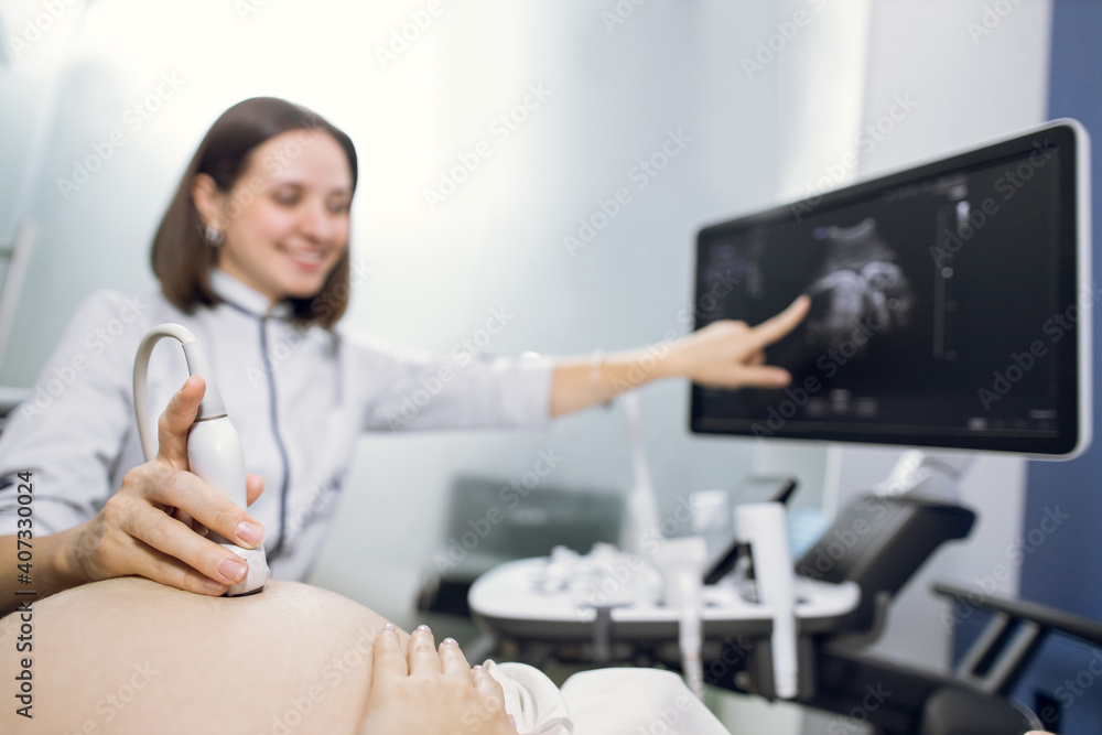 Cropped shot of a pregnant woman during ultrasound scanning at the ...