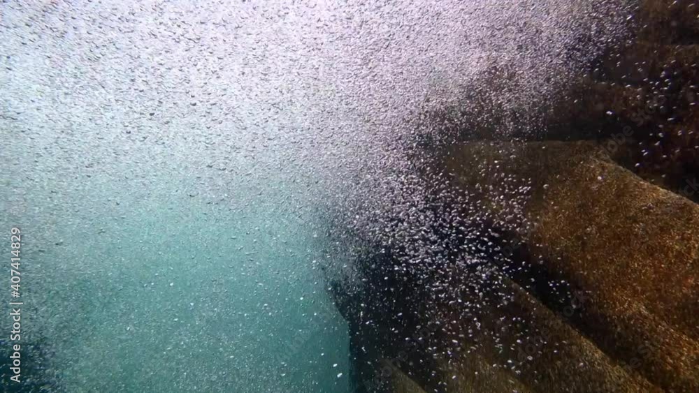 Water churned boils and bubbles underwater of fast flowing waters of ...