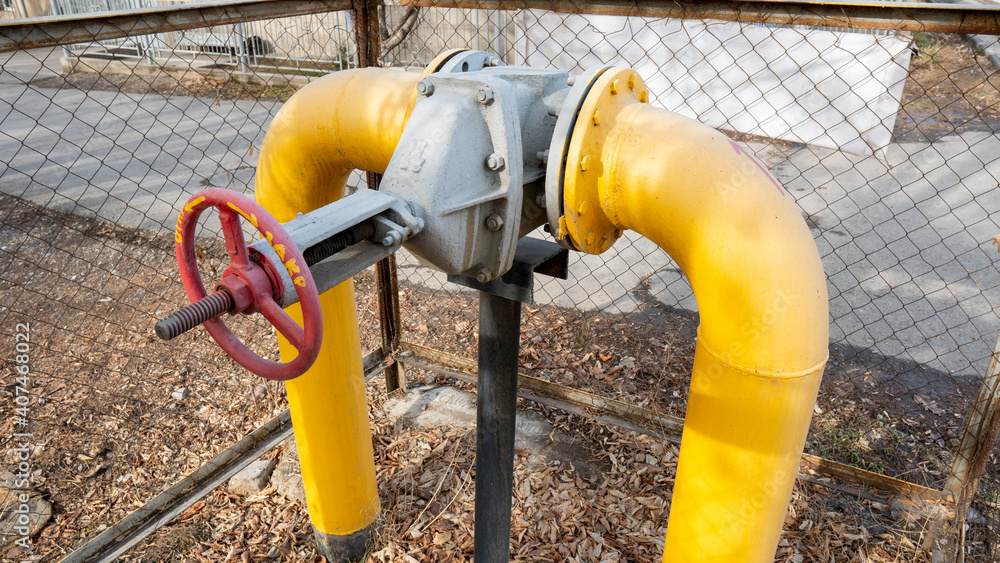 Backbone pipe with valve painted in yellow, for the transportation of ...