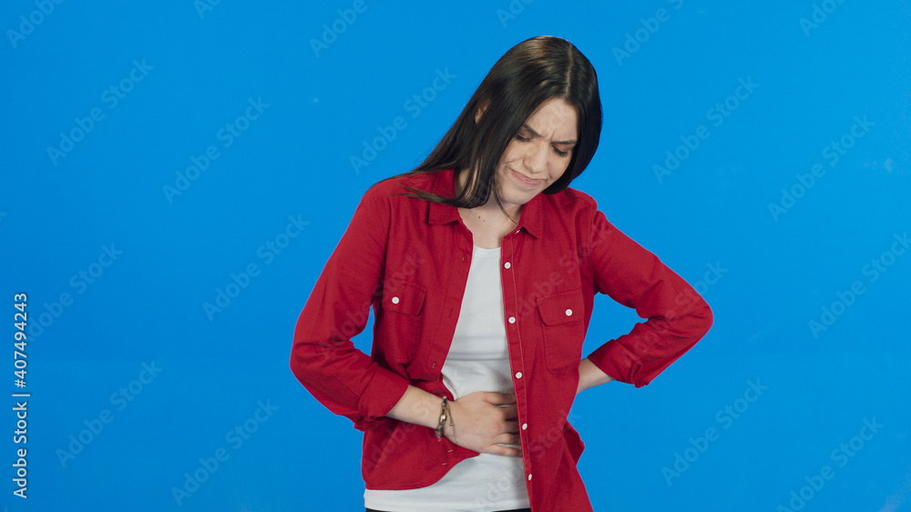 Female suffering from digestive problems. Bearded woman wearing white t ...