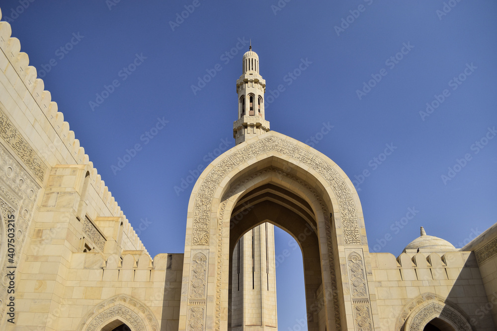 Arch, domes and minaret in Sultan Qaboos Grand Mosque in contrast with ...