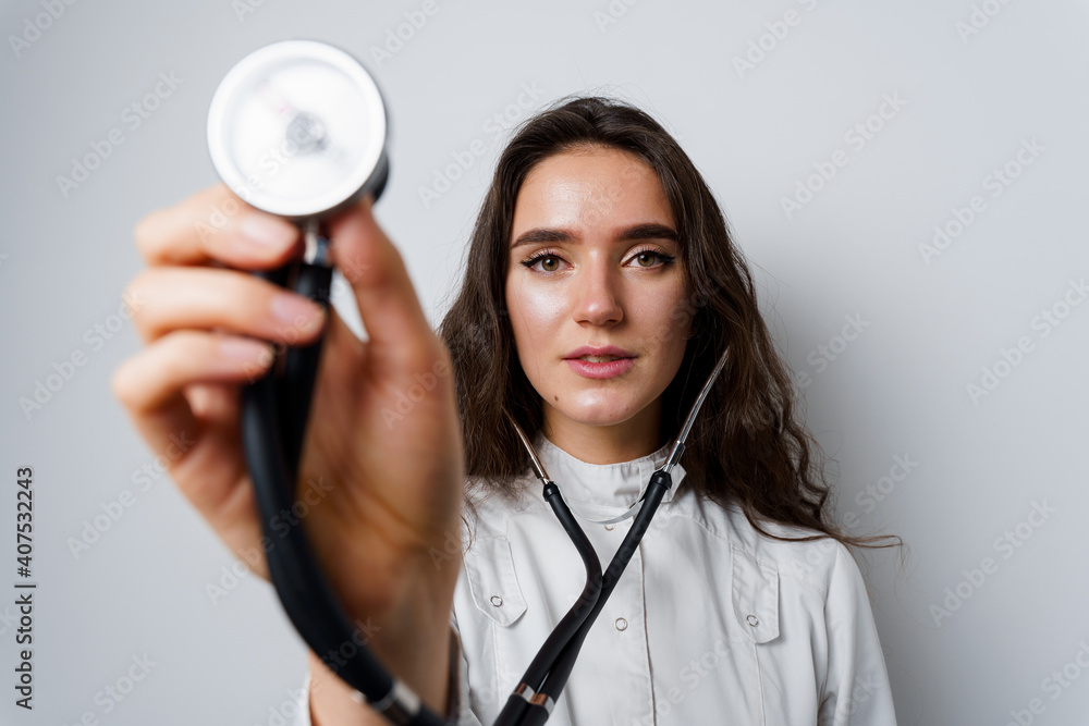 Medical student girl doing auscultation to patient. Doctor uses ...