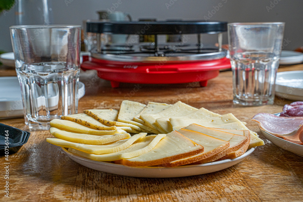 Detail photograph of a French raclette with all the typical ingredients ...
