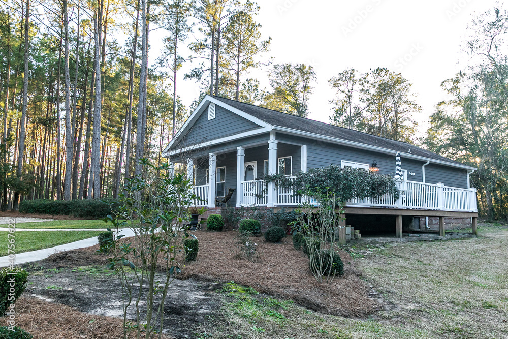 Small blue gray mobile home with a front and side porch with white ...