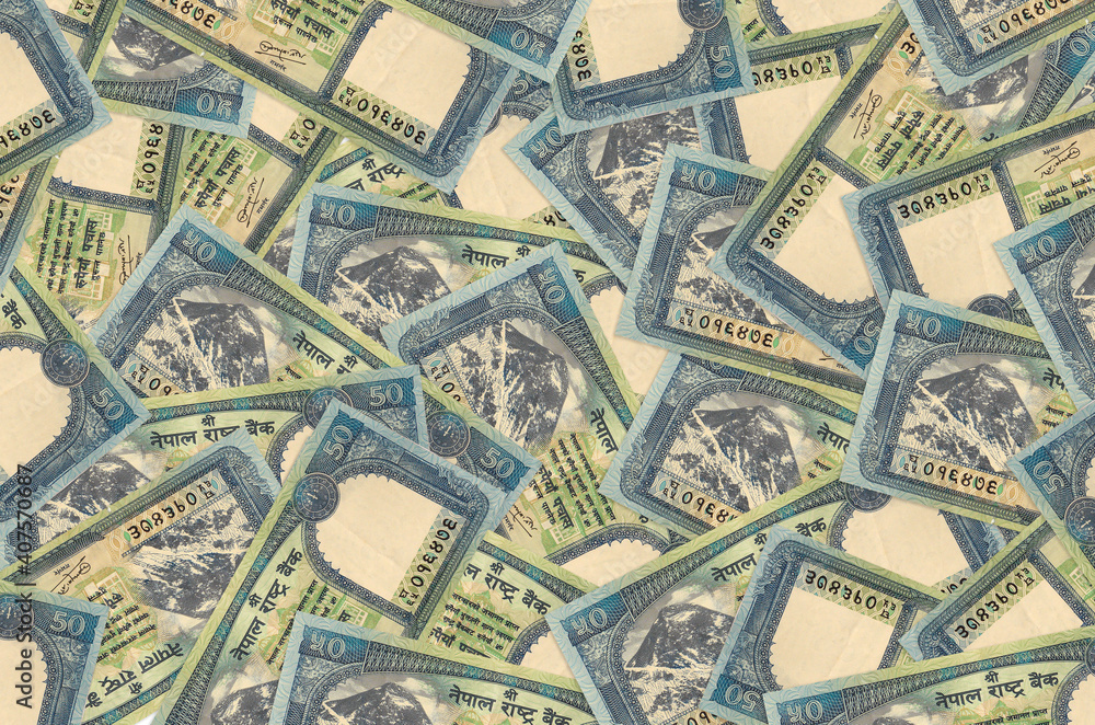 50 Nepalese rupees bills lies in big pile. Rich life conceptual ...