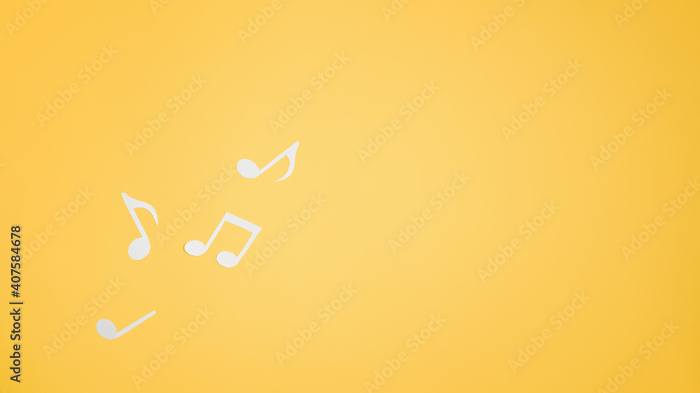 Musical notes cut from paper, flat lay. Top view music layout on yellow ...