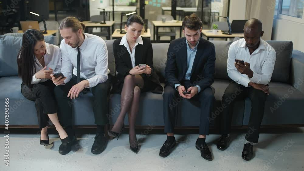 Group of people sitting in the waiting room and use smartphones, the ...