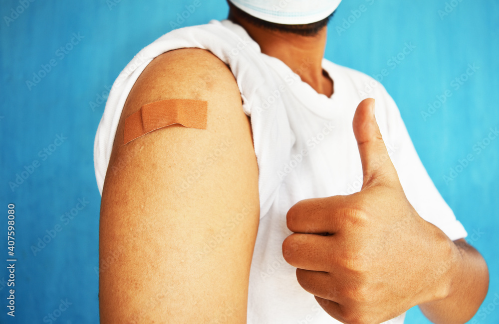 Asian man using adhesive bandage plaster on her arm showing thumb up ...