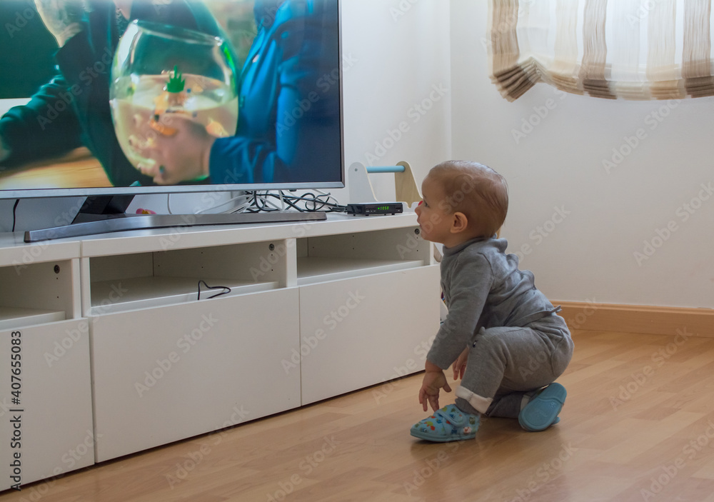 Cute Baby Watching TV. Side View Of Adorable Toddler In Pajama Watching ...