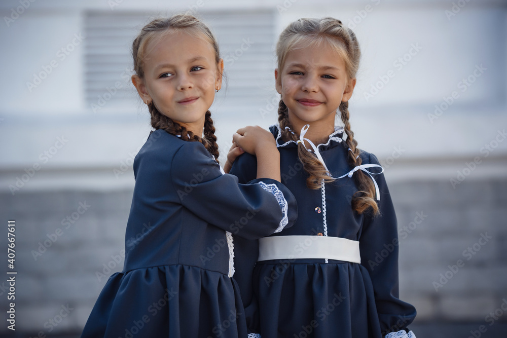 Charming little girls in retro dress walking in town on a sunny summer ...