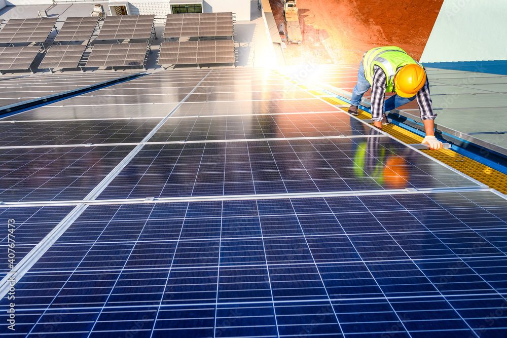 Engineers are examining solar panels in an installation at a power ...