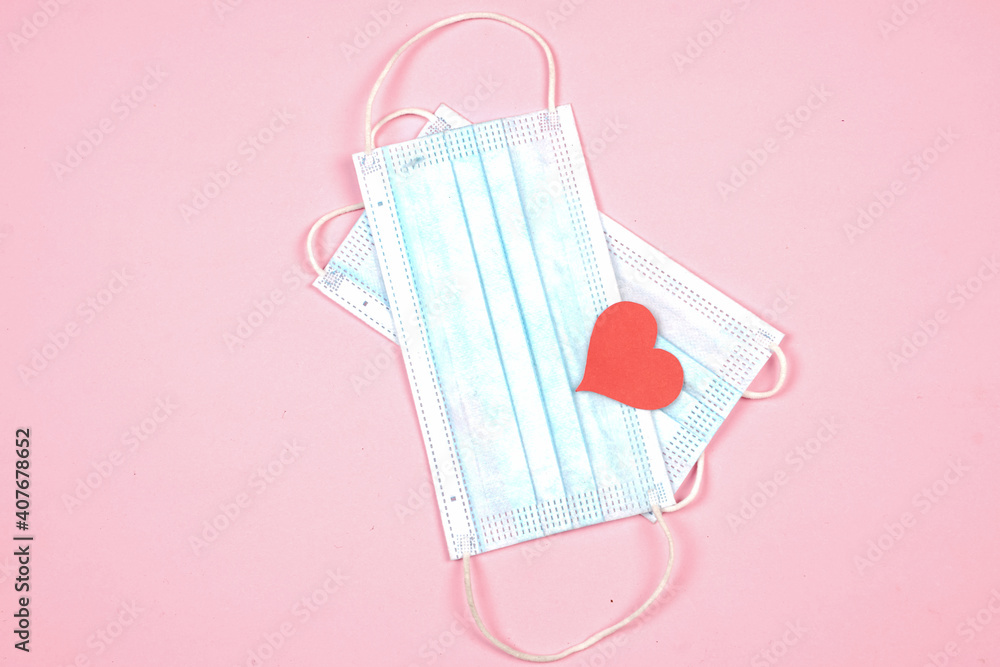 Heart shaped paper taped to the health mask. Symbol to our love in ...