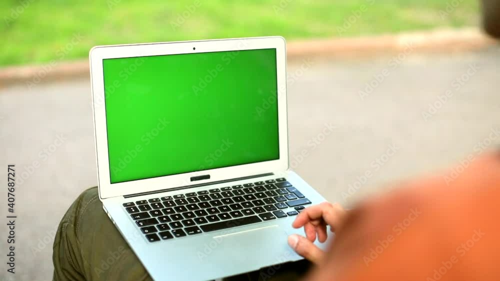 Green screen chroma key laptop blank monitor in park outdoor. Mock-up ...