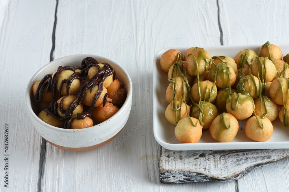 Loukoumades, luqaimat or lokma in white plate on wooden white ...