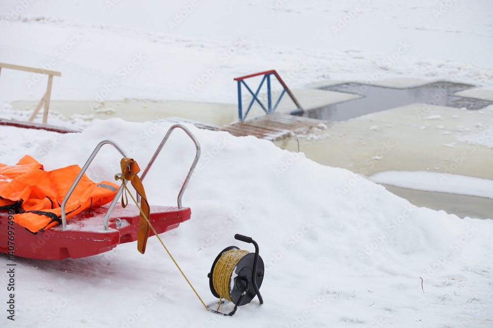 Professional red sledge with orange life jackets and safety rope on ...
