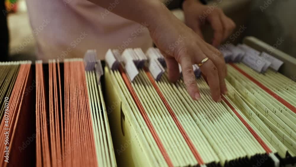 young woman goes through documents in home archive, looking for the ...
