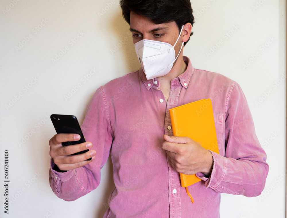 Handsome man wears mask to prevent virus and for protection while using ...