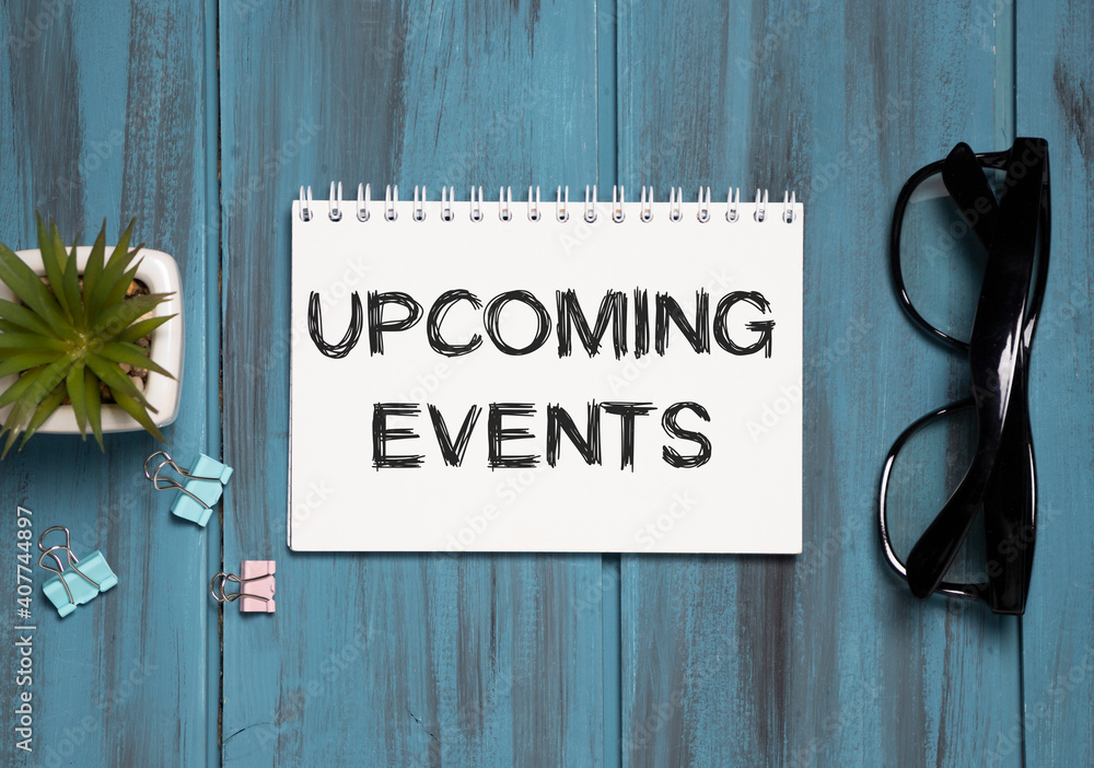 Text Upcoming Events written in notepad, Office desk with electronic ...