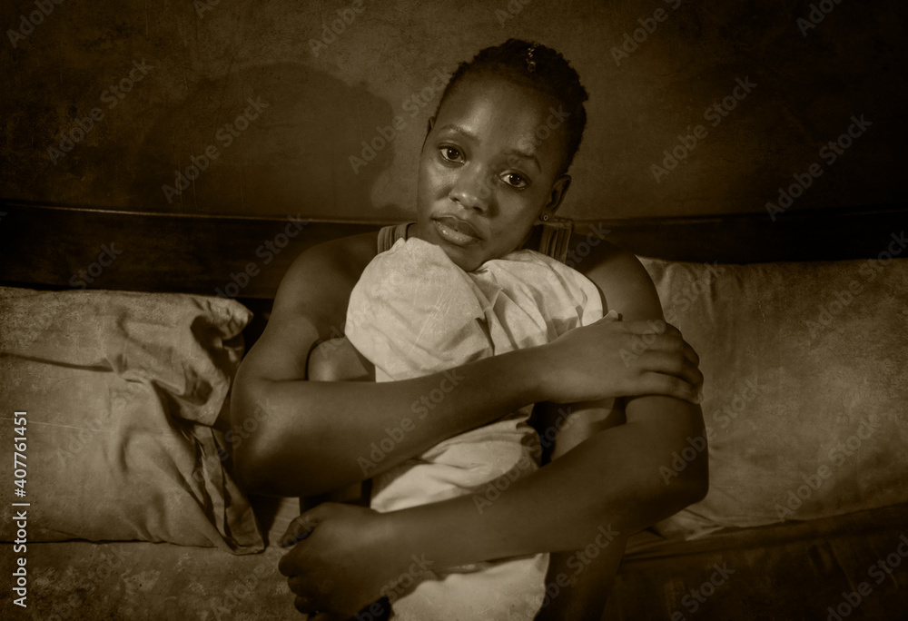 dramatic home portrait of young sick and depressed black afro American ...